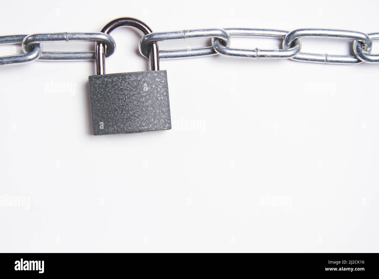 Chain and padlock on an isolated background. A locked padlock hangs on ...