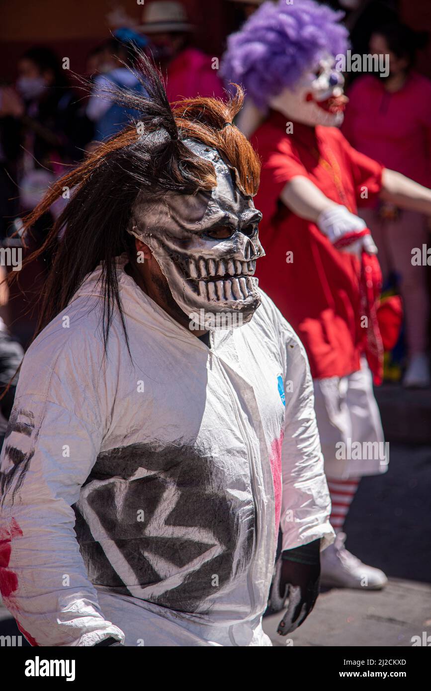 A parade of festive party goers joining in celebration. San Miguel de ...