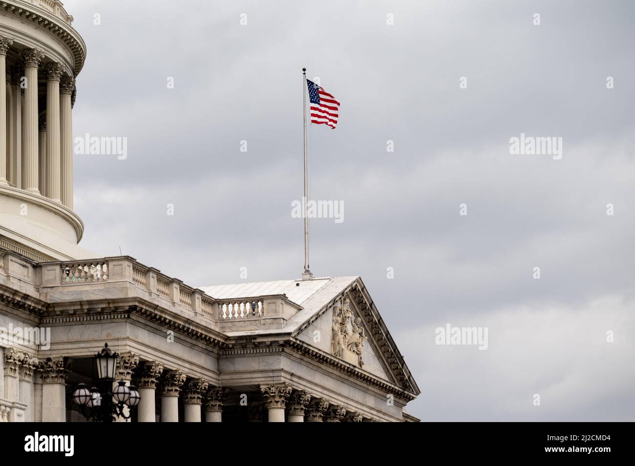 American flag flying above the U.S. Capitol Stock Photo - Alamy