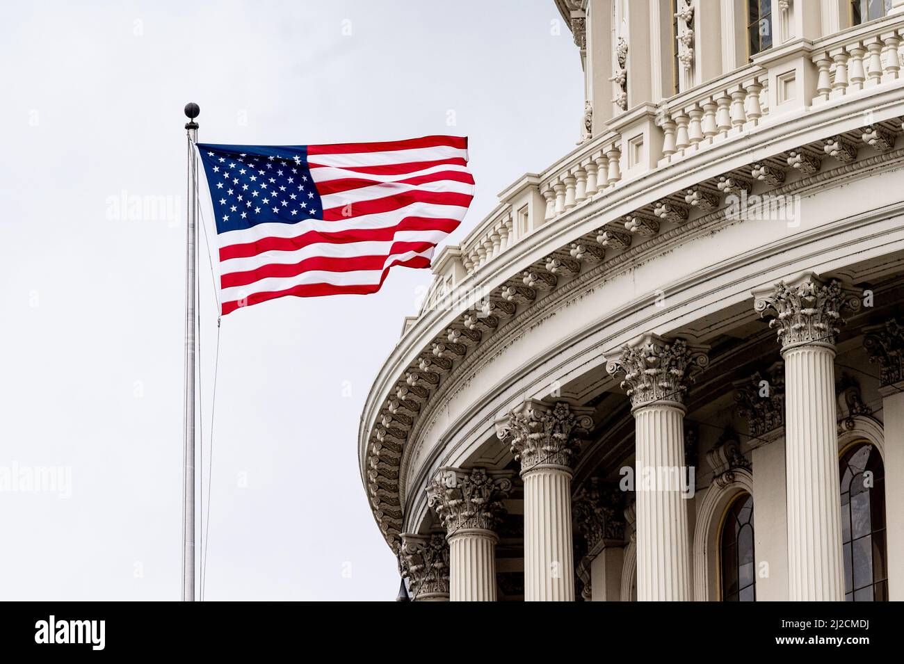 American flag flying above the U.S. Capitol Stock Photo - Alamy