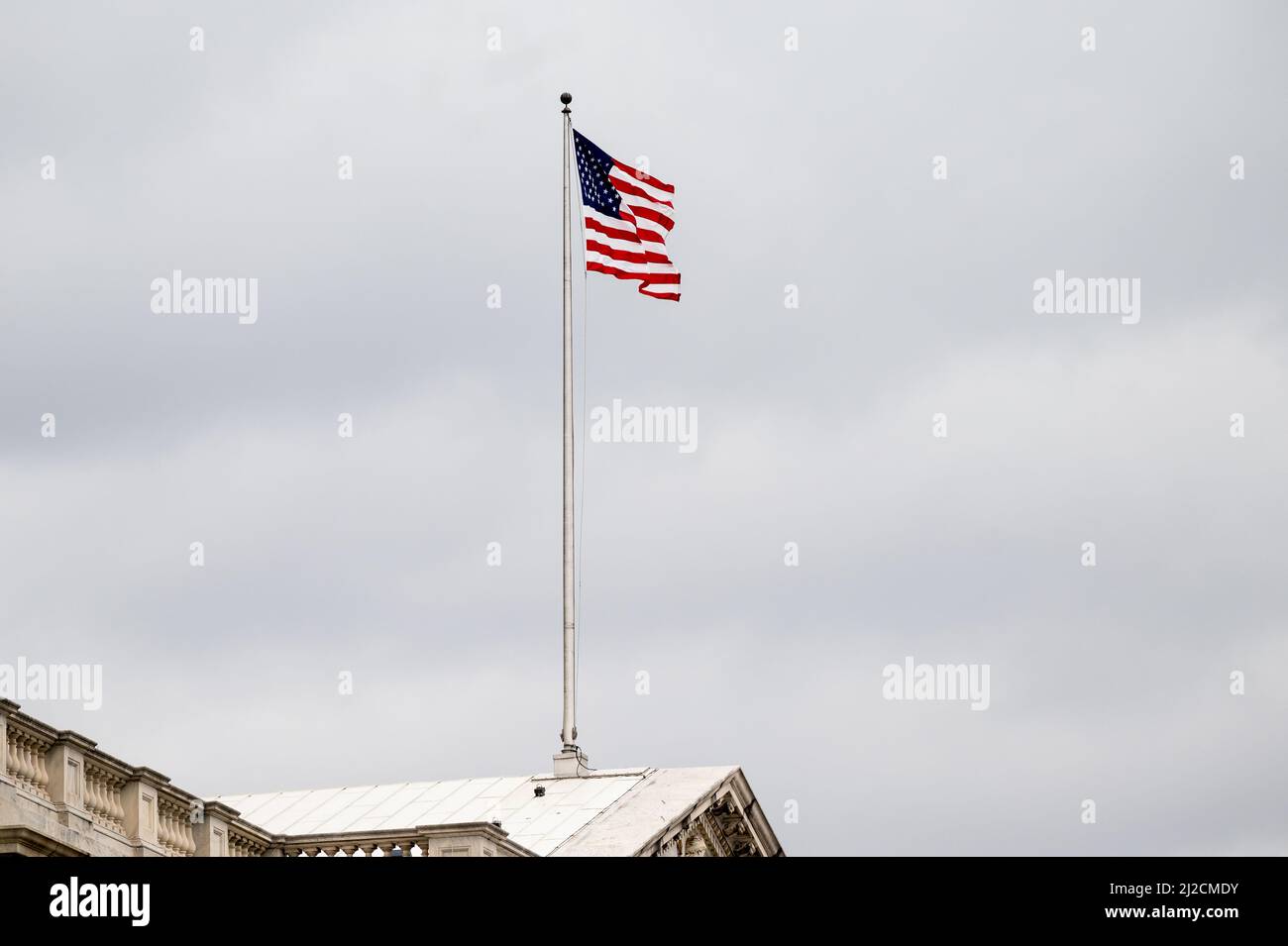 American flag flying above the U.S. Capitol Stock Photo - Alamy
