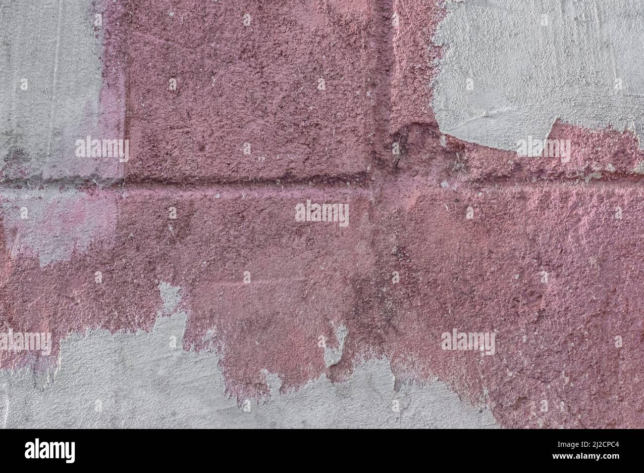 Old wall of concrete blocks in pink paint and cement stains texture ...