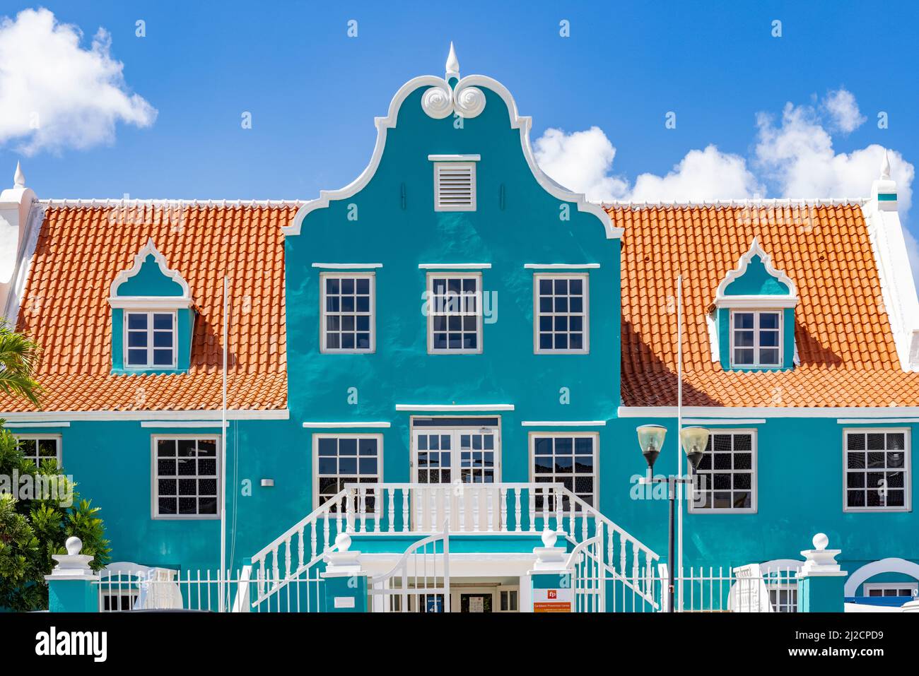 Beautiful building with a turquoise facade, white details and an orange ...