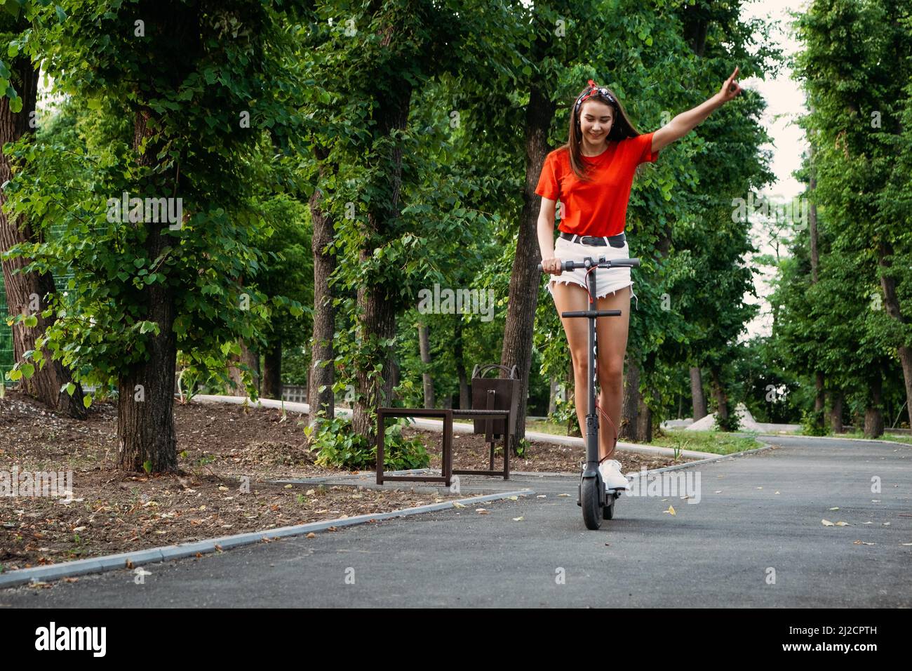 E-bikes, scooters safety. Young woman riding e scooter in urban ...