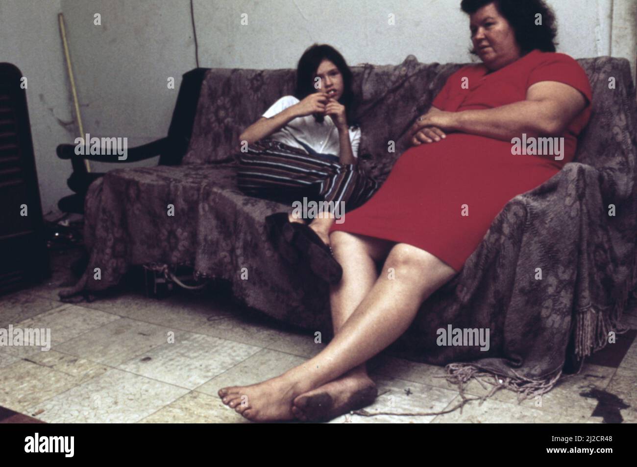 Mrs. May Watkins and one of her nine children in the living room of ...
