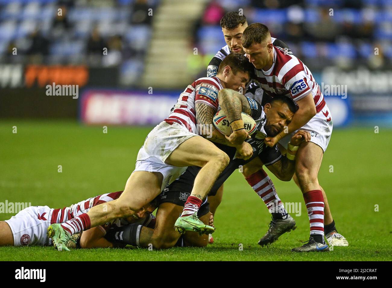 Manu Ma'u (12) of Hull FC is tackled by John Bateman (13) and Harry ...