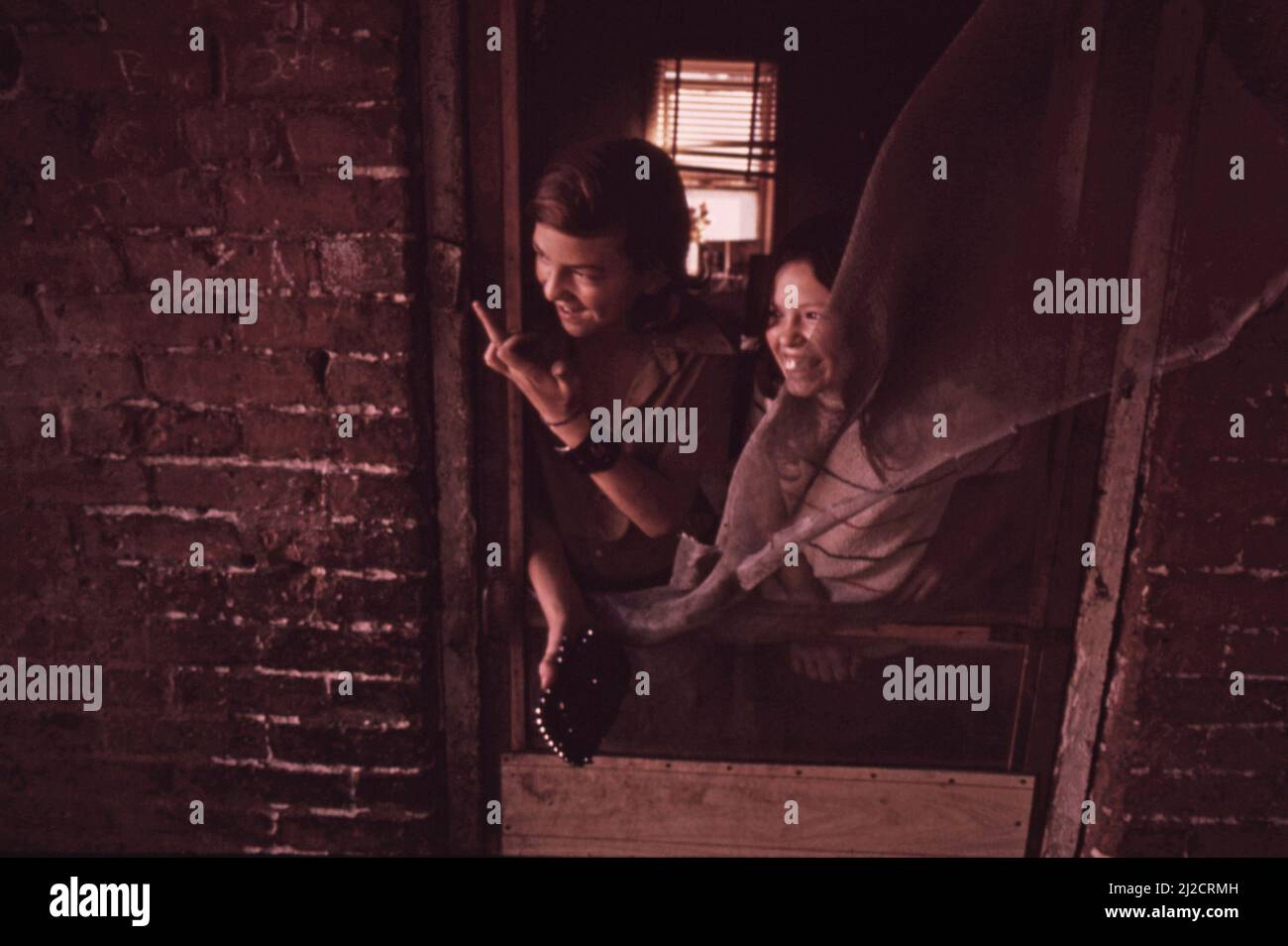Billy and Sandy Watkins call to a friend on the street from the doorway ...