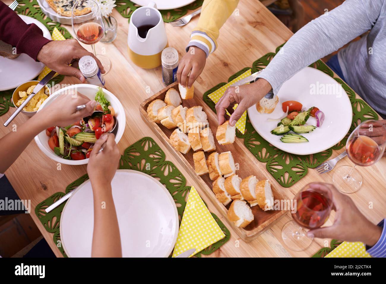 Dig in. A cropped high angle view of a group of people sharing a meal ...