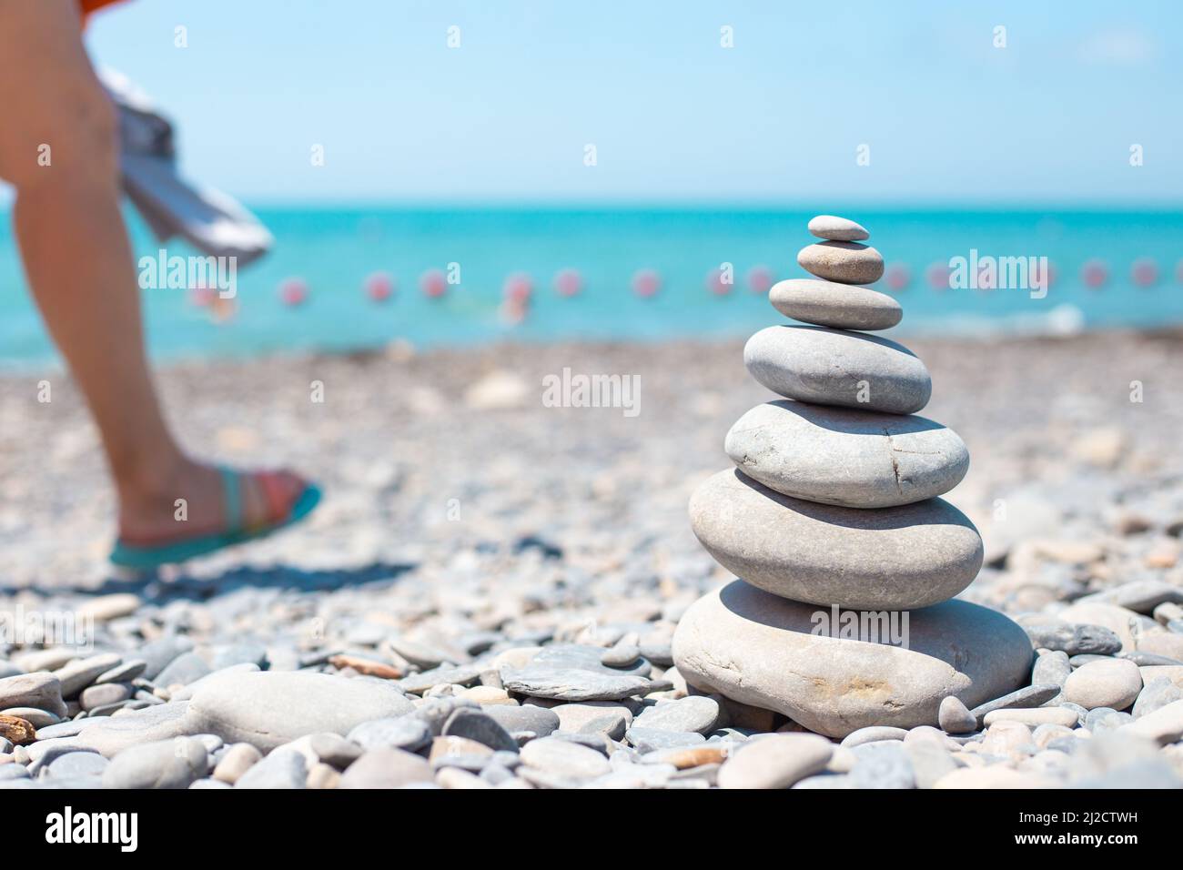 Round stones are stacked on top of each other by a pyramid on the ...