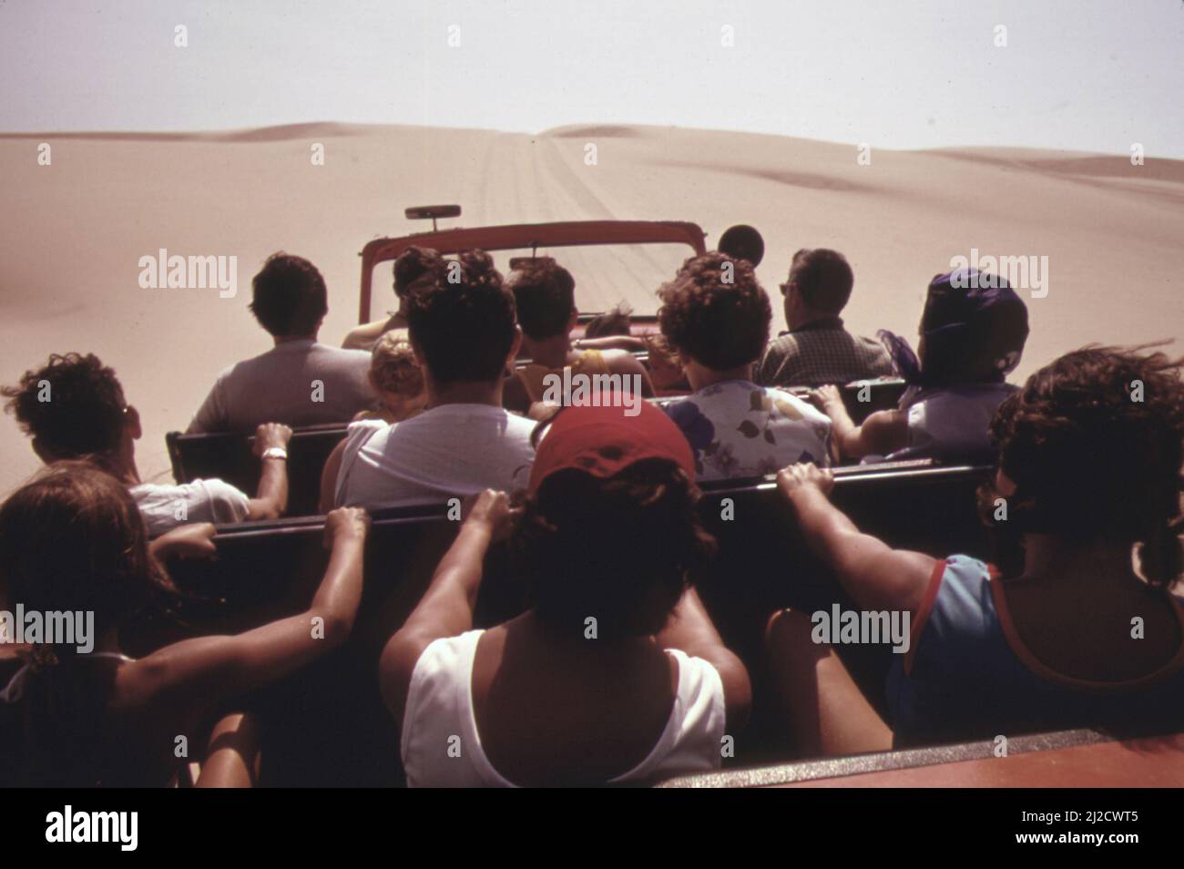 Tourists in dune buggy ride over shifting sand dunes at Silver Lake ...