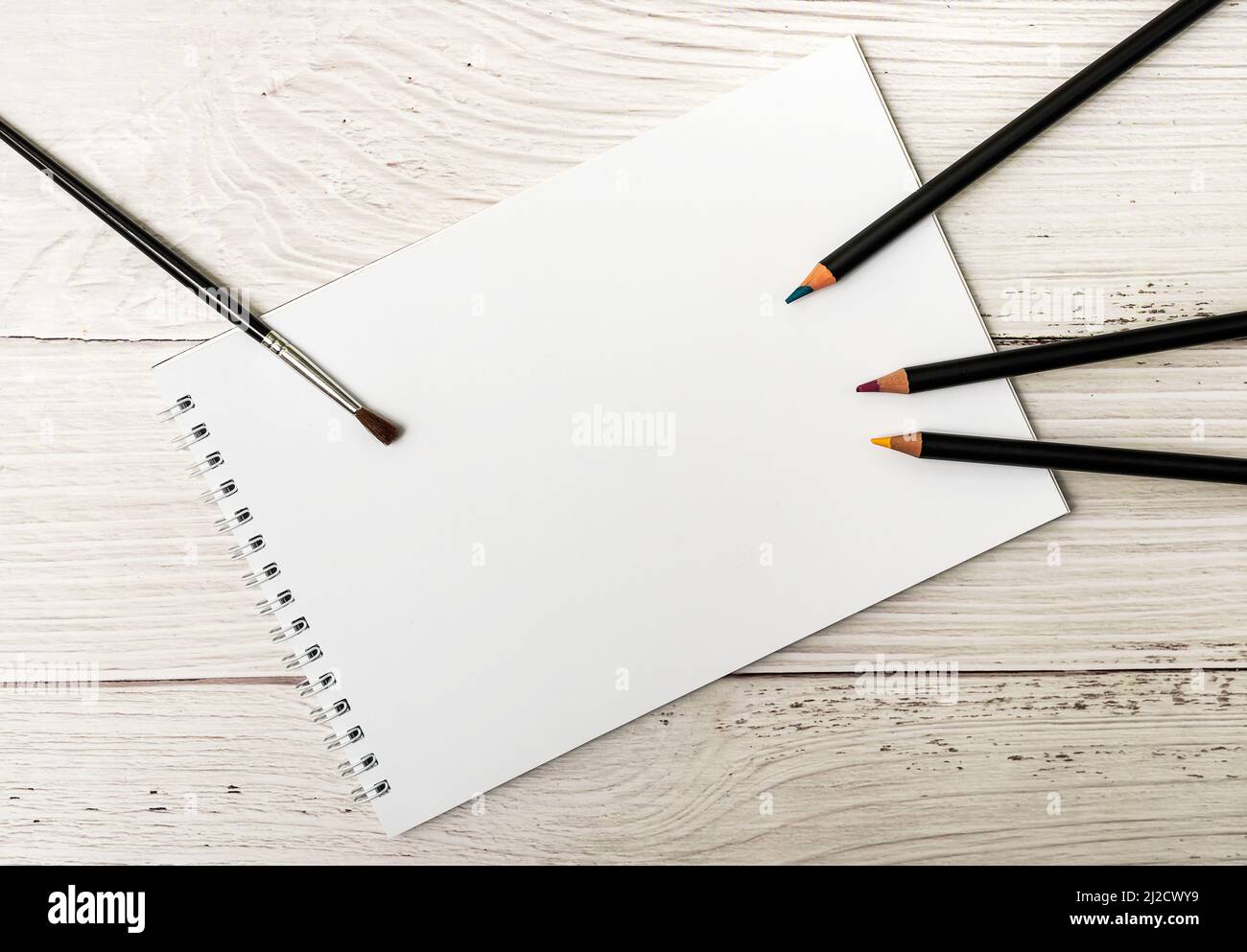 Notebook with white sheets and colored pencils for drawing on white ...