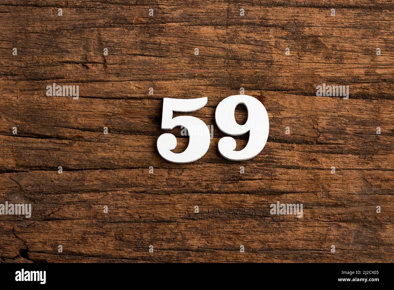 Number 59 - piece on rustic wood background Stock Photo - Alamy
