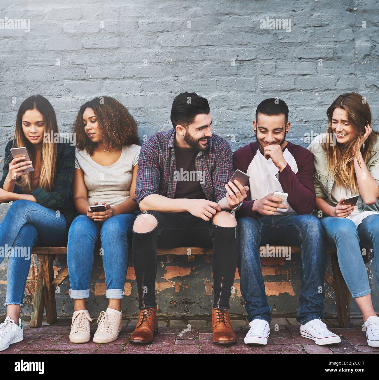 Whats life without friends and wifi. Shot of a group of young friends ...