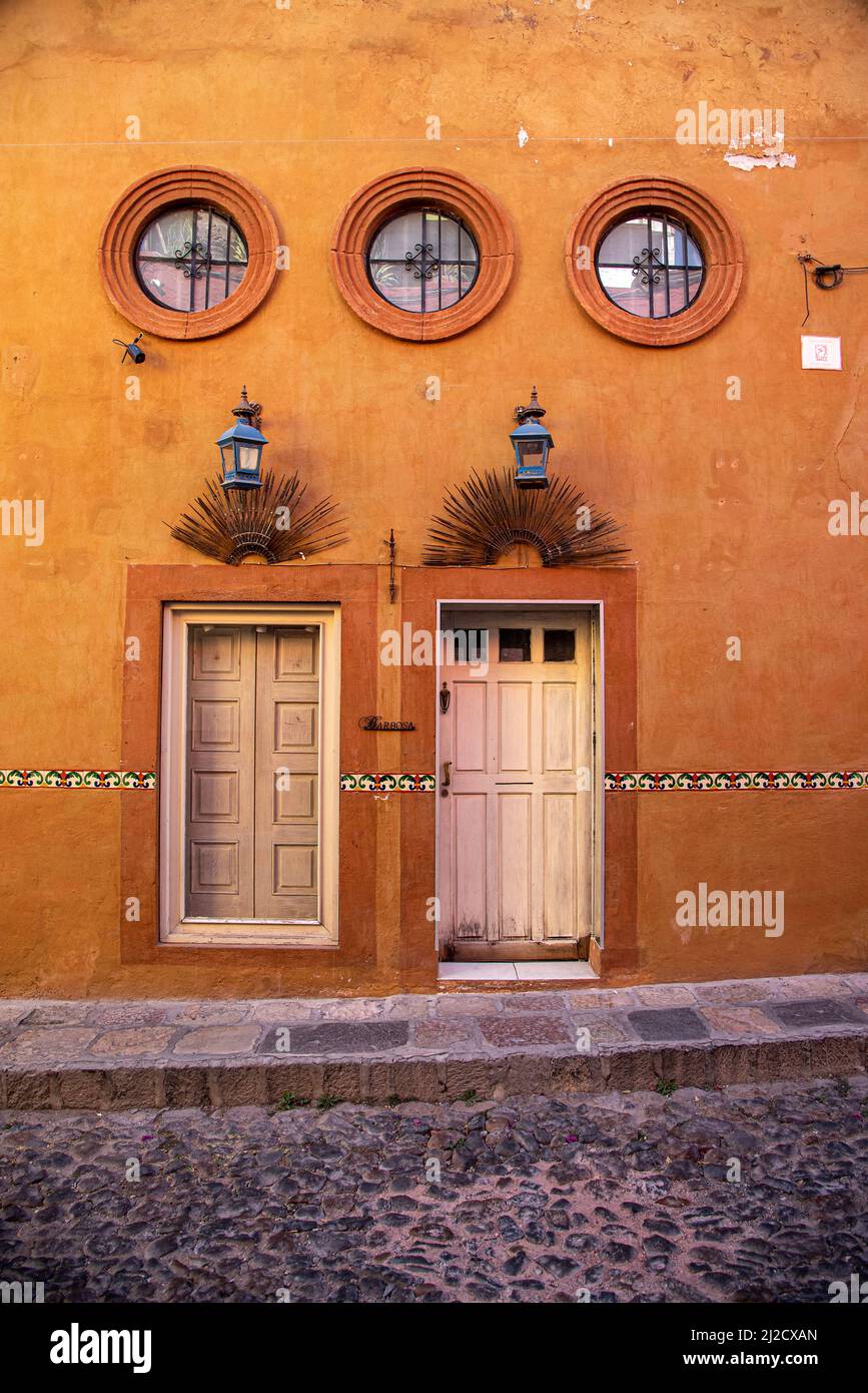 Three port hole style windows on a house. San Miguel de Allende ...