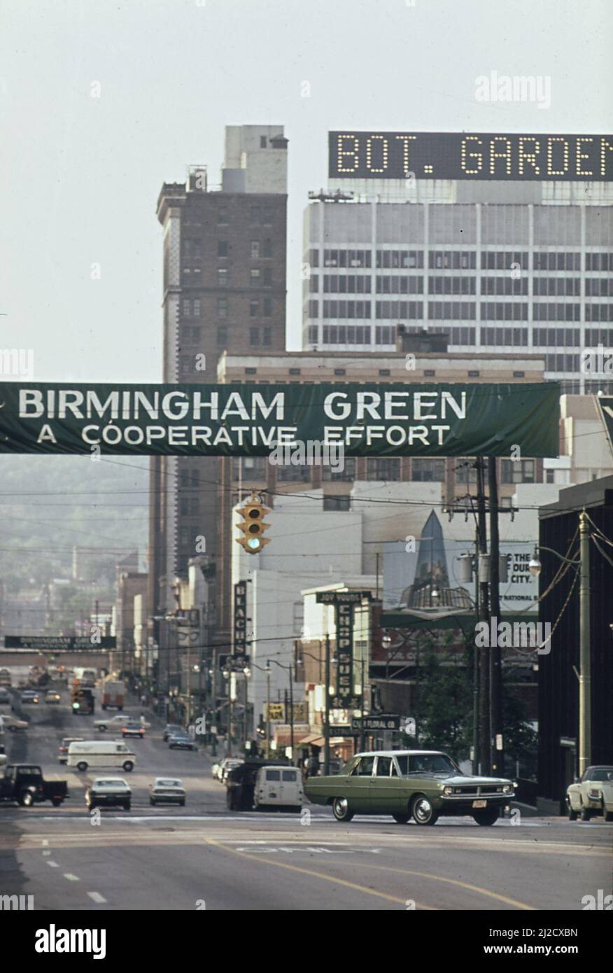 A Birmingham Green banner hangs across a busy street in the downtown ...