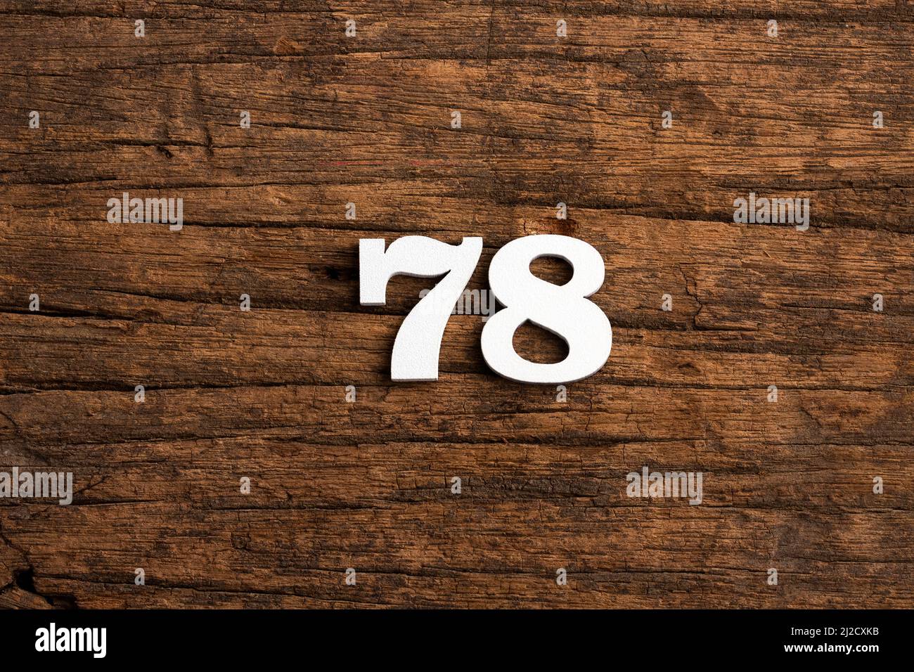 Number 78 in wood, isolated on rustic background Stock Photo - Alamy