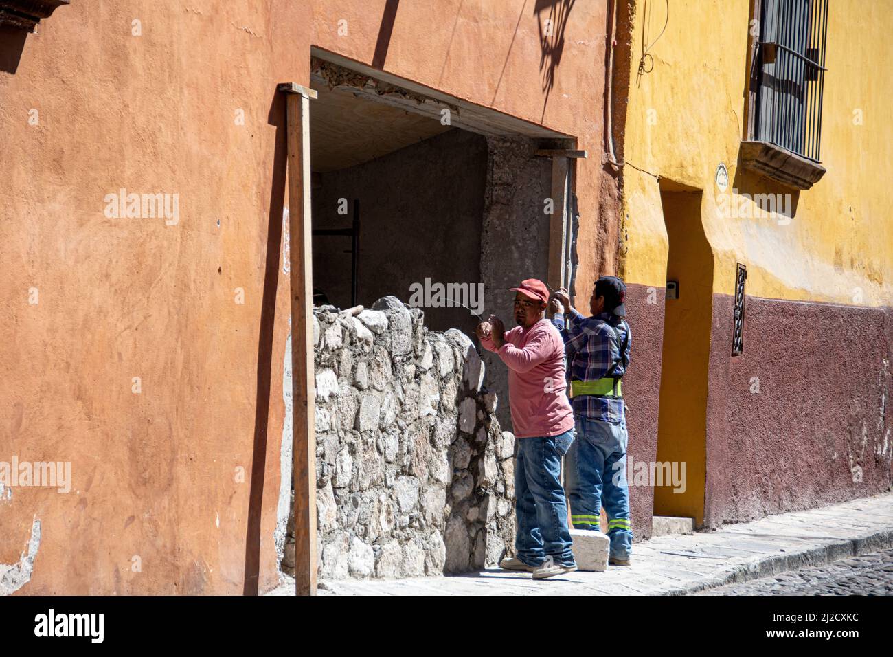 Several Mexican construction workers working on a building. San Miguel ... Several Mexican construction workers working on a building. San Miguel ...