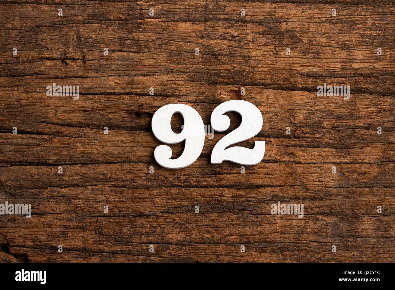 Number 92 in wood, isolated on rustic background Stock Photo - Alamy