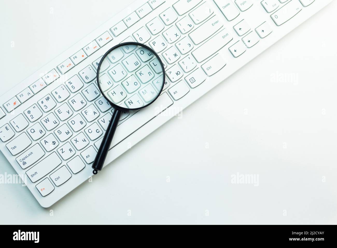 magnifying glass on computer keyboard Stock Photo - Alamy