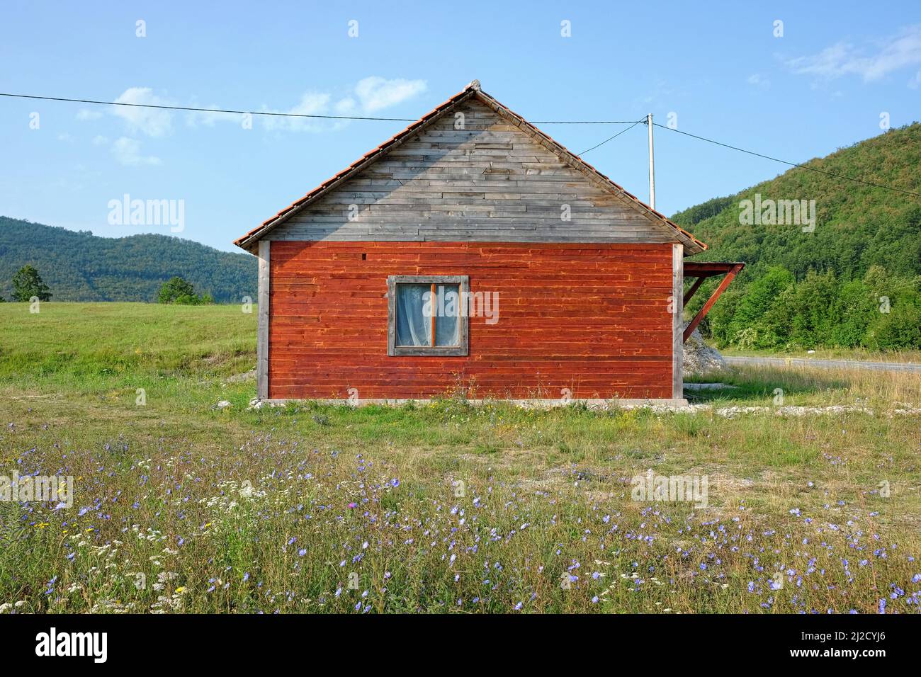 red wooden prefabricated building in Montenegro Stock Photo - Alamy