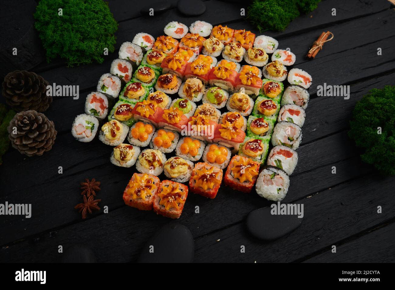 Above view of various sushi and rolls placed on stone board. Japanese ...