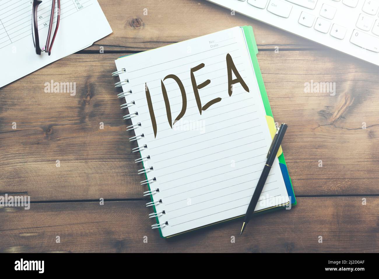 idea write on notepad and keyboard on table Stock Photo - Alamy