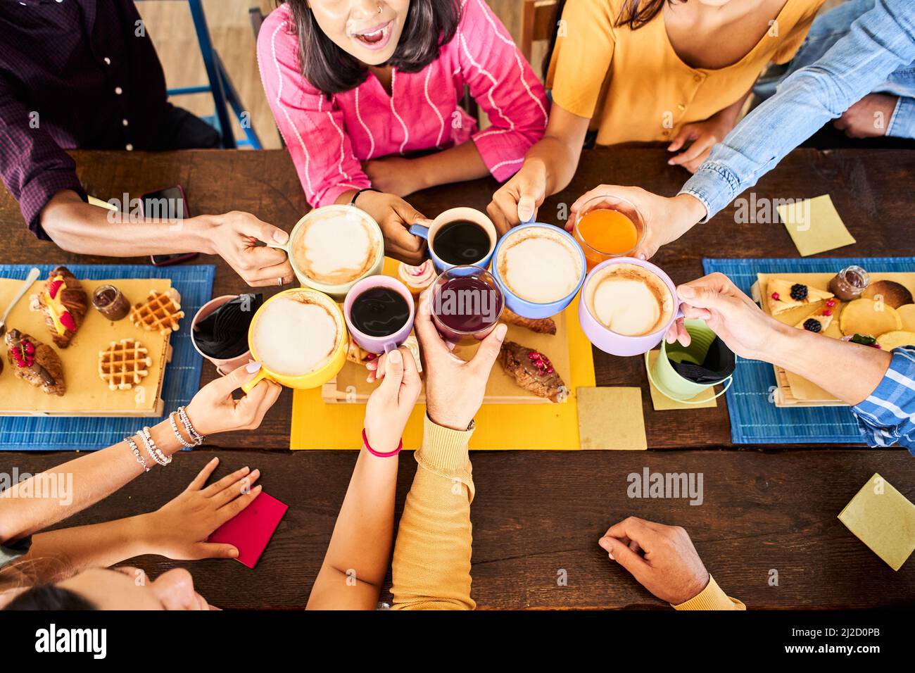 Top view of close up hands of Multicultural People having breakfast ...