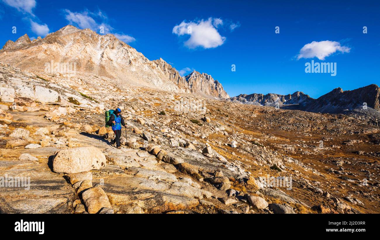 Backpacker crossing Bishop Pass, Kings Canyon National Park, California ...