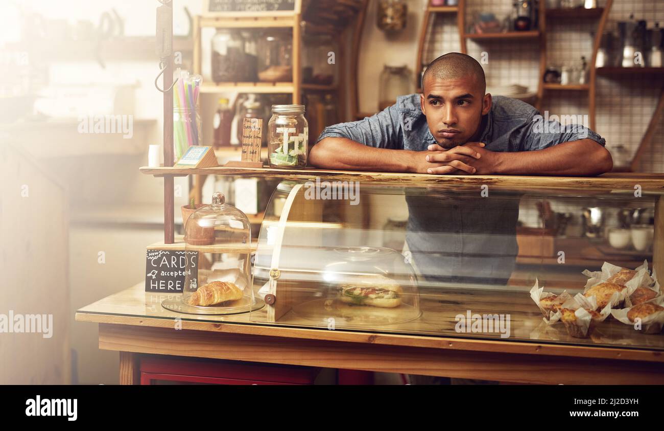 Where are all the customers. Shot of a young man standing behind the ...