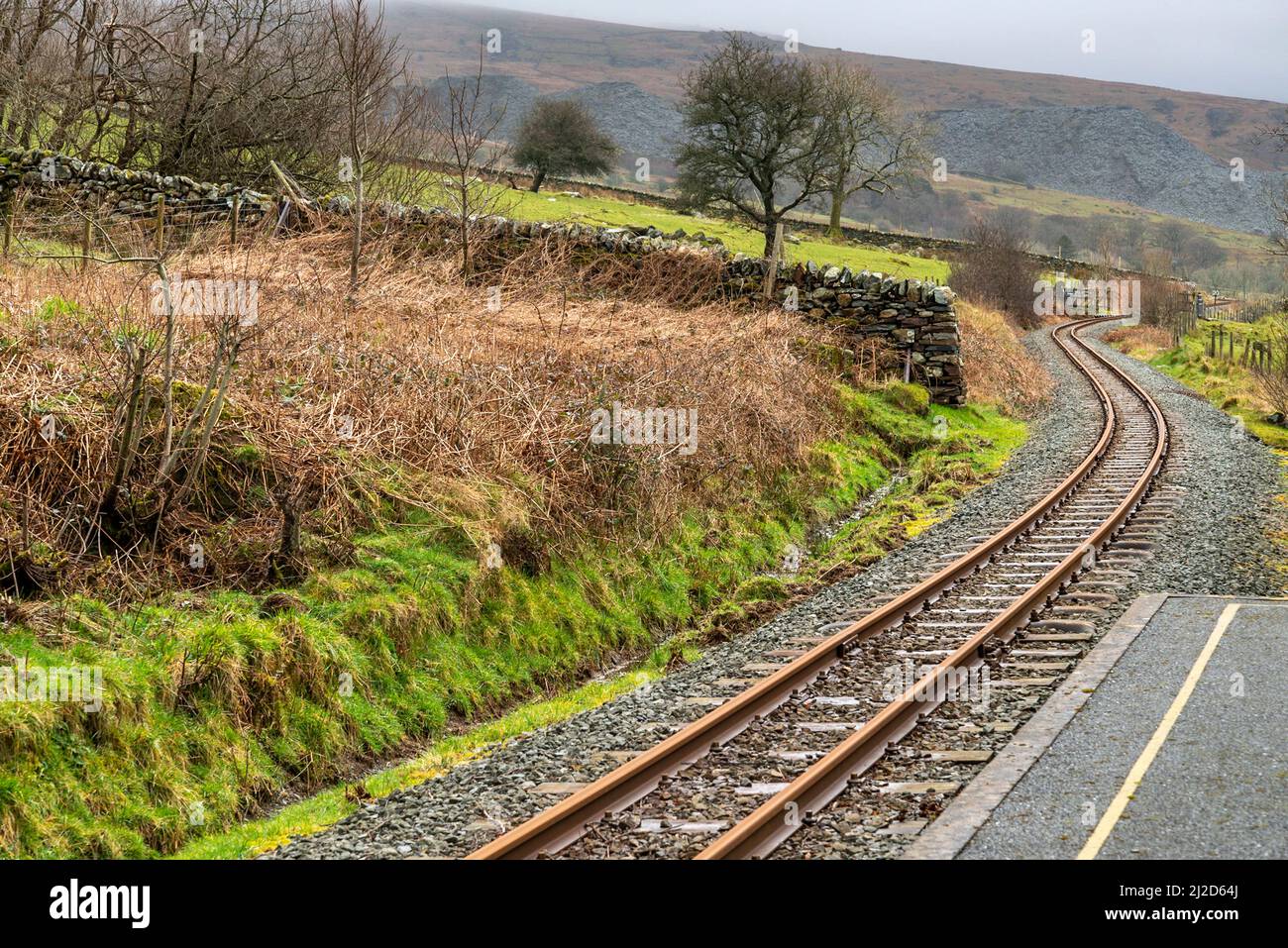 Railway track by the platform of the small train halt,that winds it's ...
