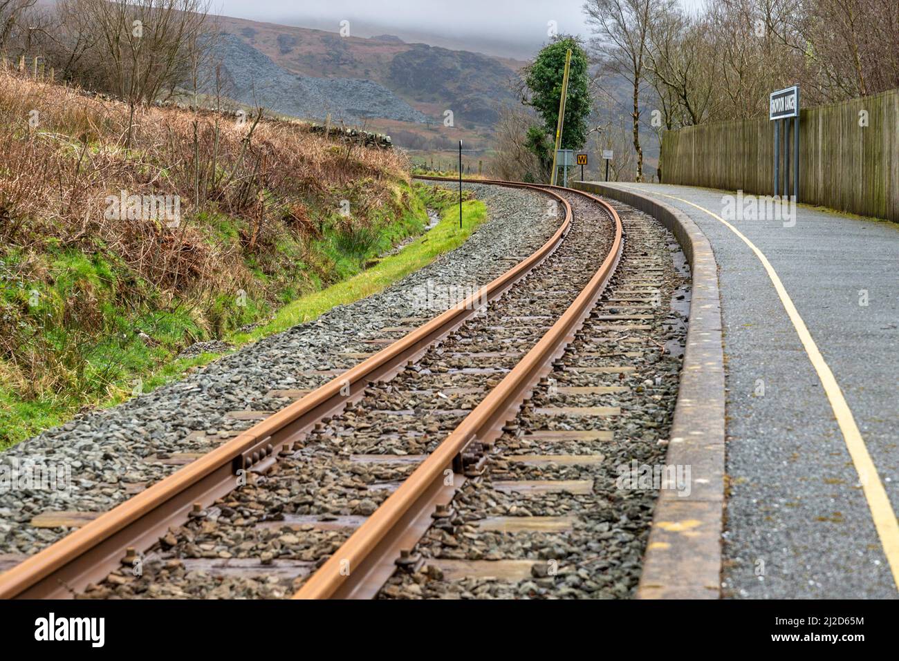 Railway track by the platform of the small train halt,that winds it's ...
