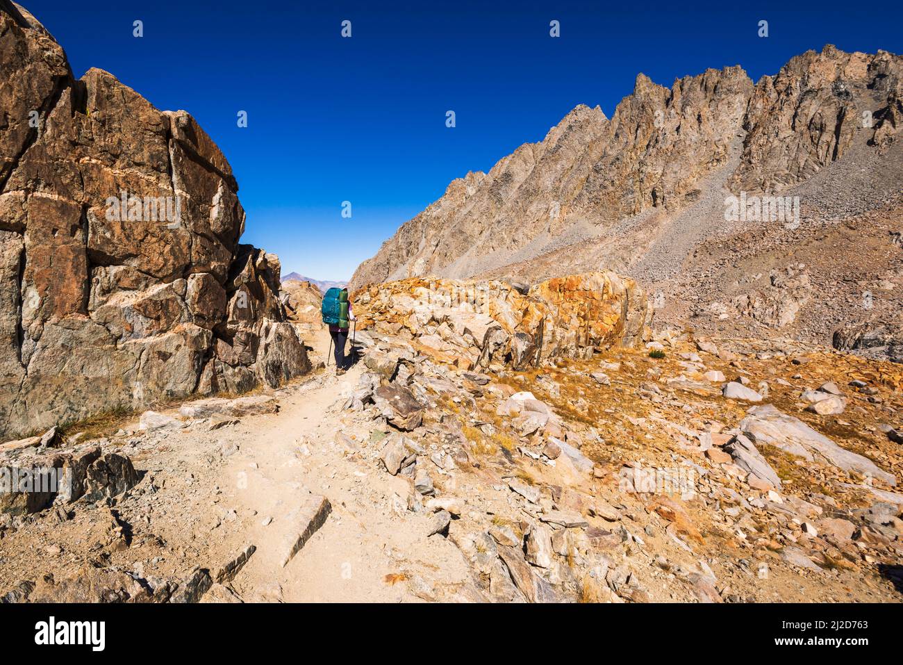 Backpacker crossing Bishop Pass, John Muir Wilderness, California USA ...