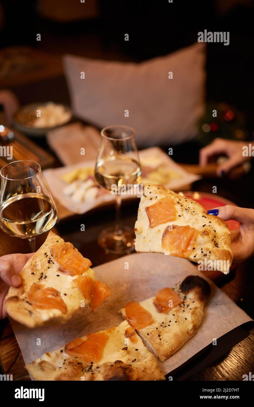 Celebrating with glasses of alcohol in hands. Happy female friends ...