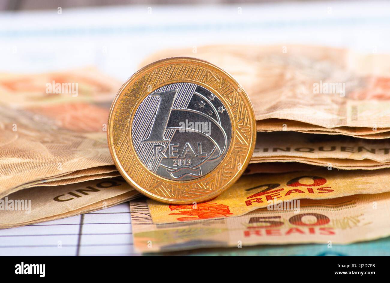 Finance concept. Brazilian money banknotes and coins. one real coin ...