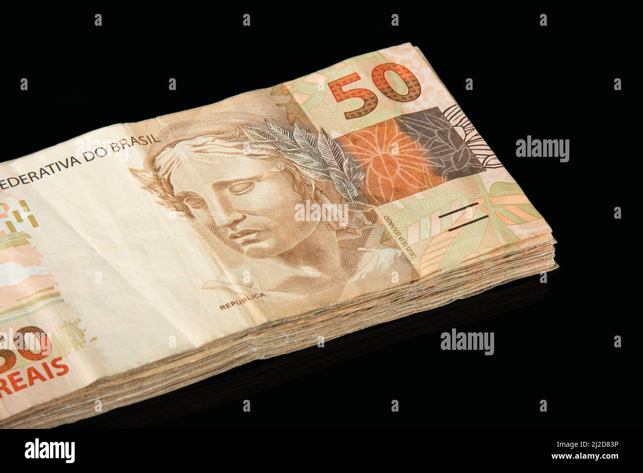 Brazilian money. 50 reais banknotes. Brazilian finance concept. Black ...