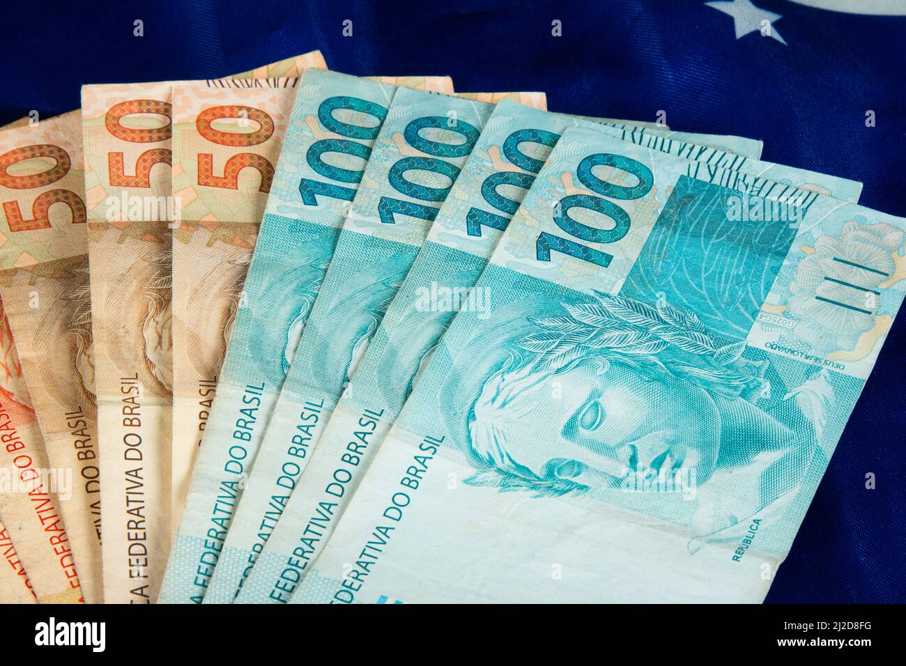 Brazilian money banknotes with Brazilian flag in the background Stock ...