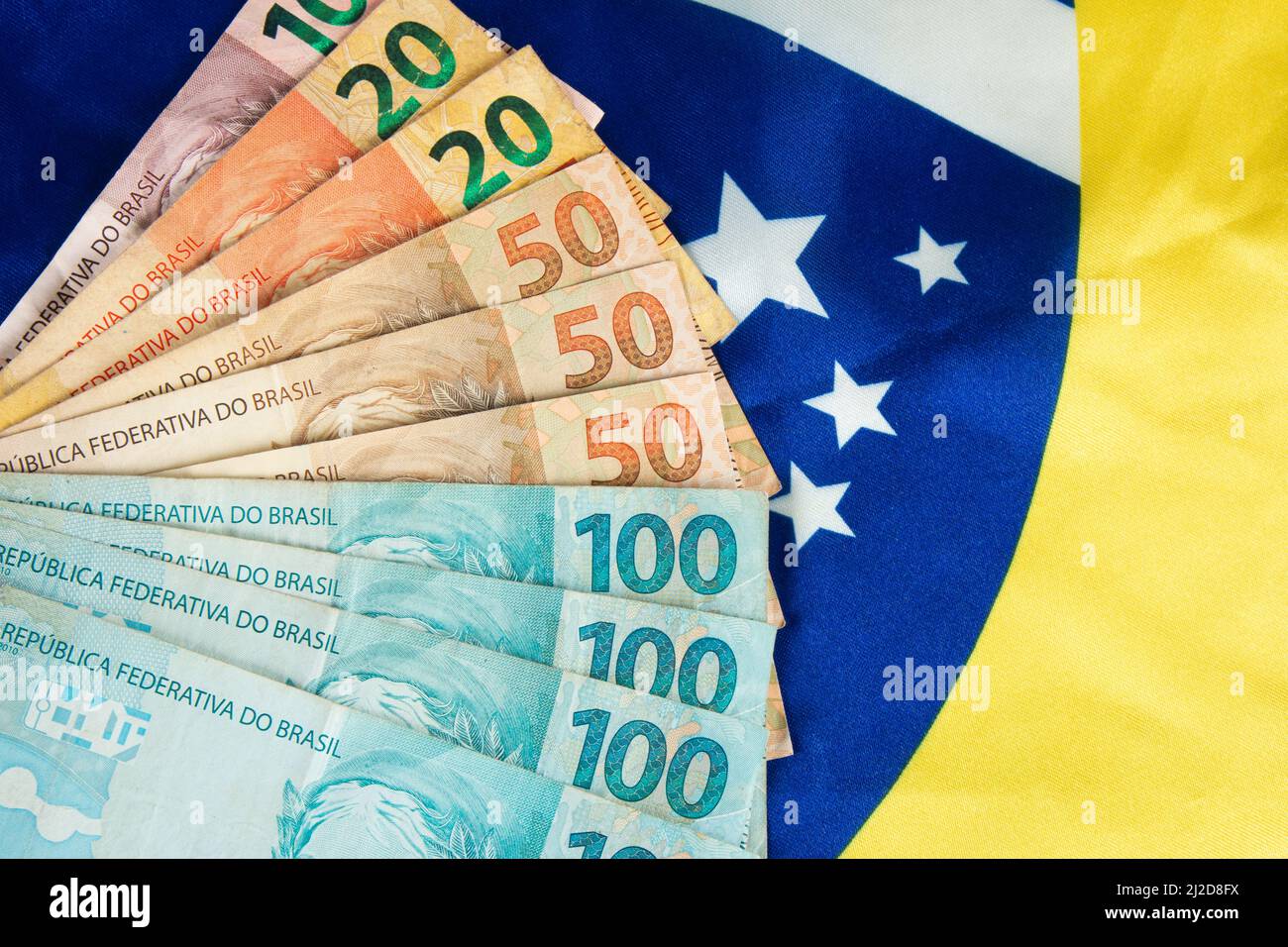Brazilian money banknotes with Brazilian flag in the background Stock ...