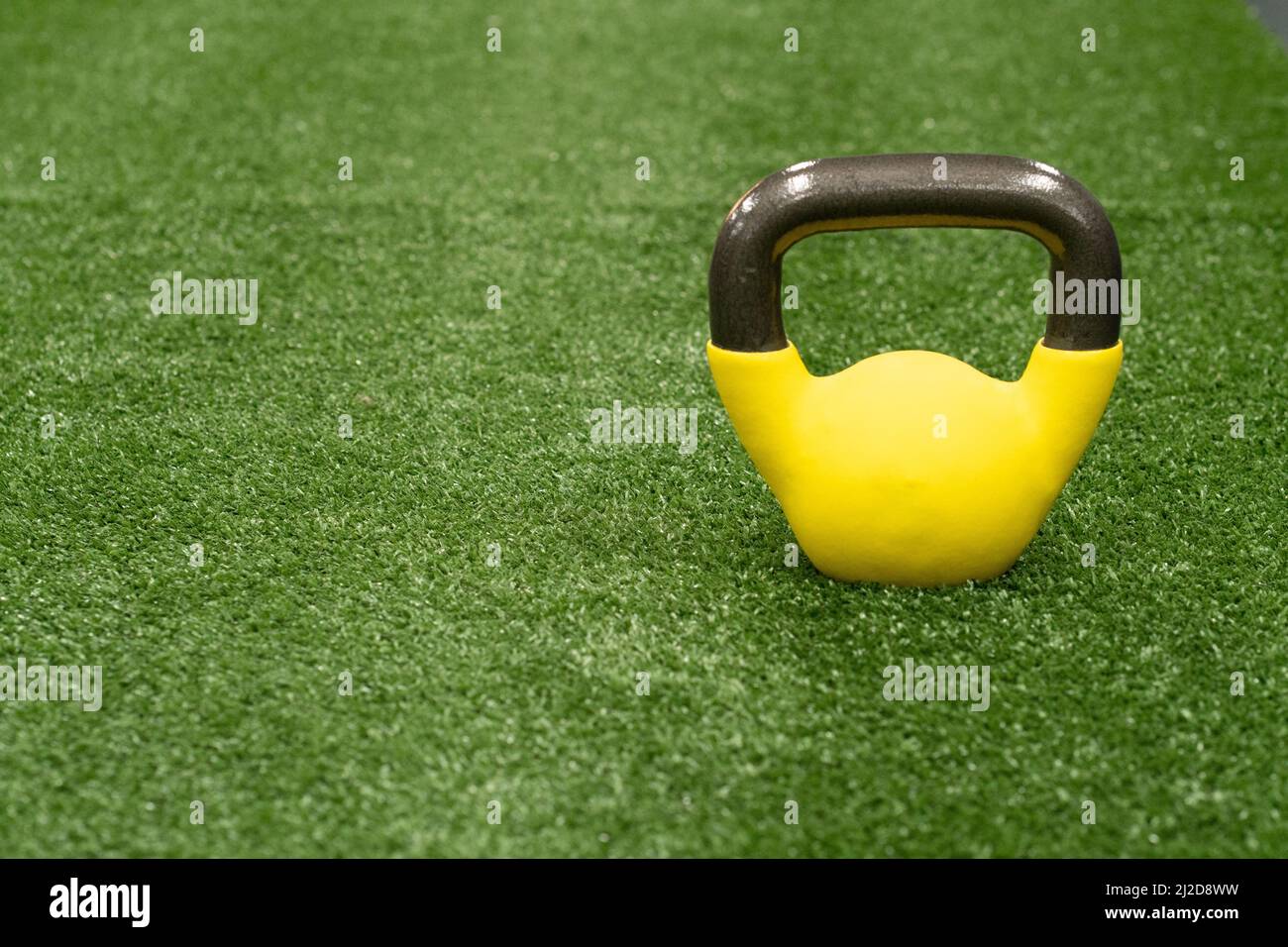 Yellow kettlebell weight isolated exercise, in the afternoon workout ...