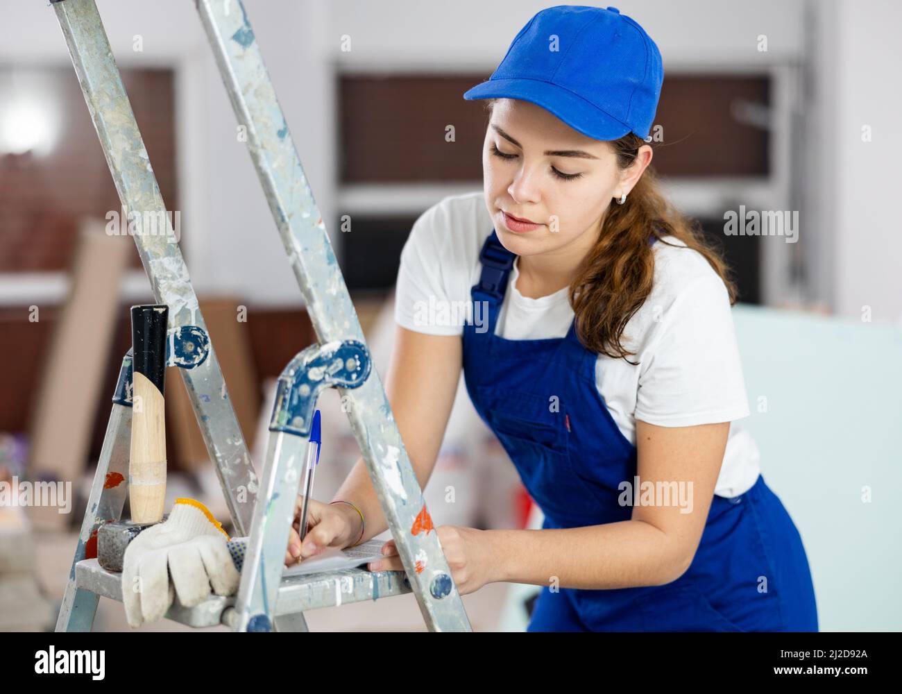 Young woman builder filling documentation in construction site Stock ...