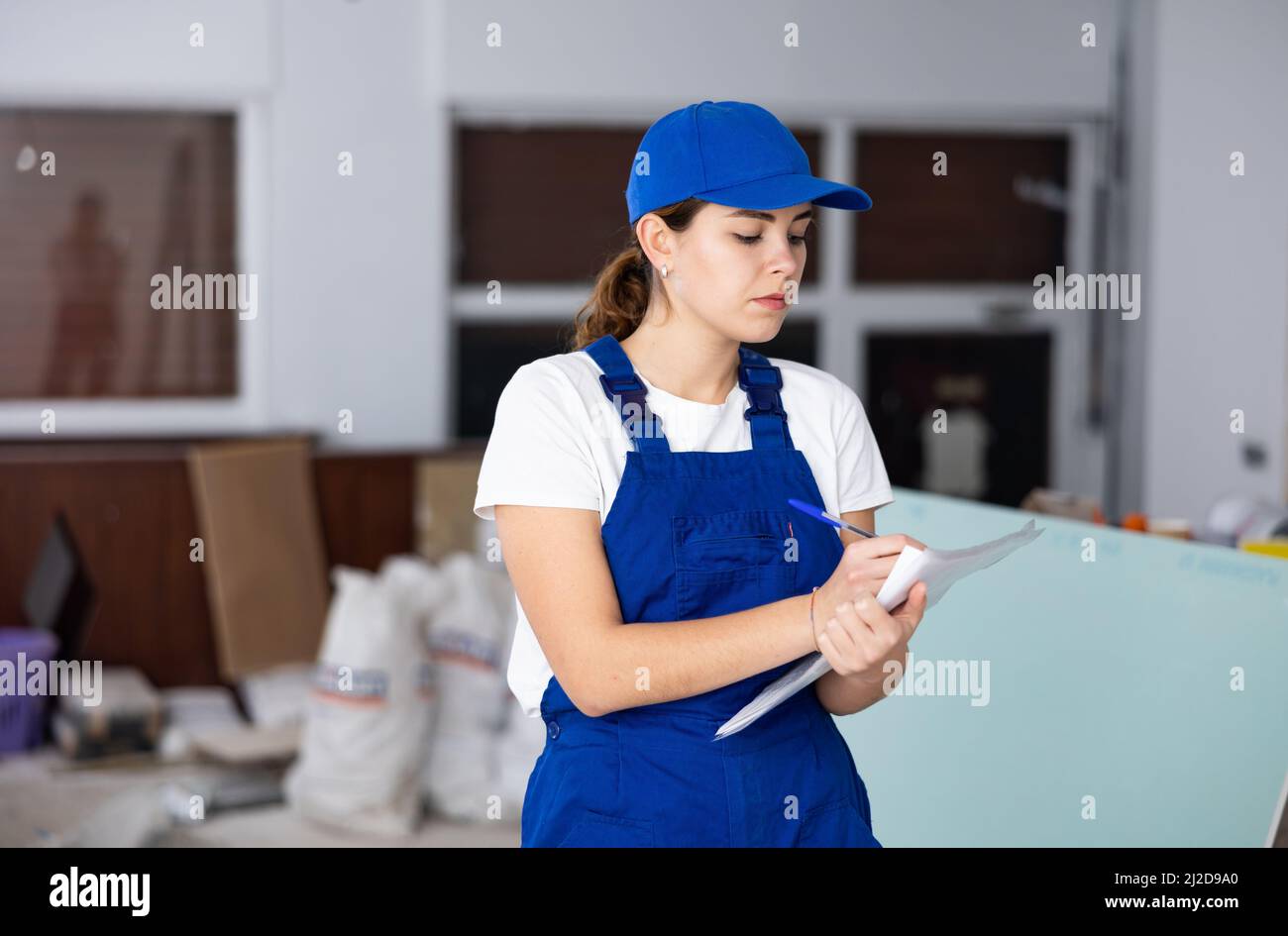 Young woman builder filling documentation in construction site Stock ...
