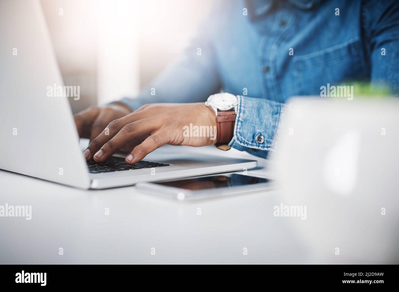 Just another day in the office. Closeup shot of an unrecognizable businessman using a laptop in ...