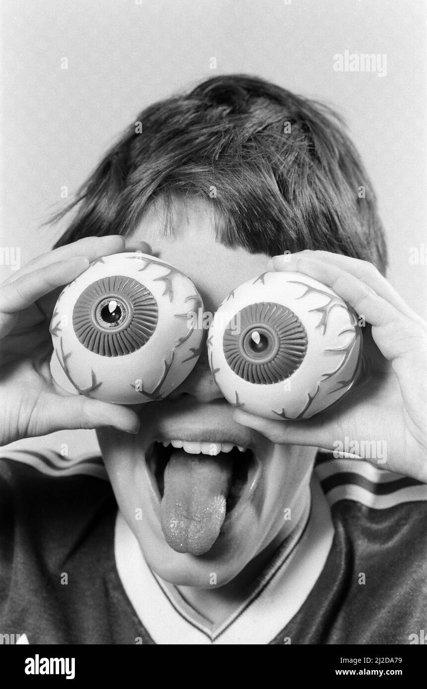 A young boy holding fake eye ball toys up to his eyes. 21st October ...