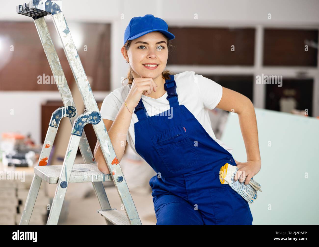 Woman builder standing in apartment Stock Photo - Alamy