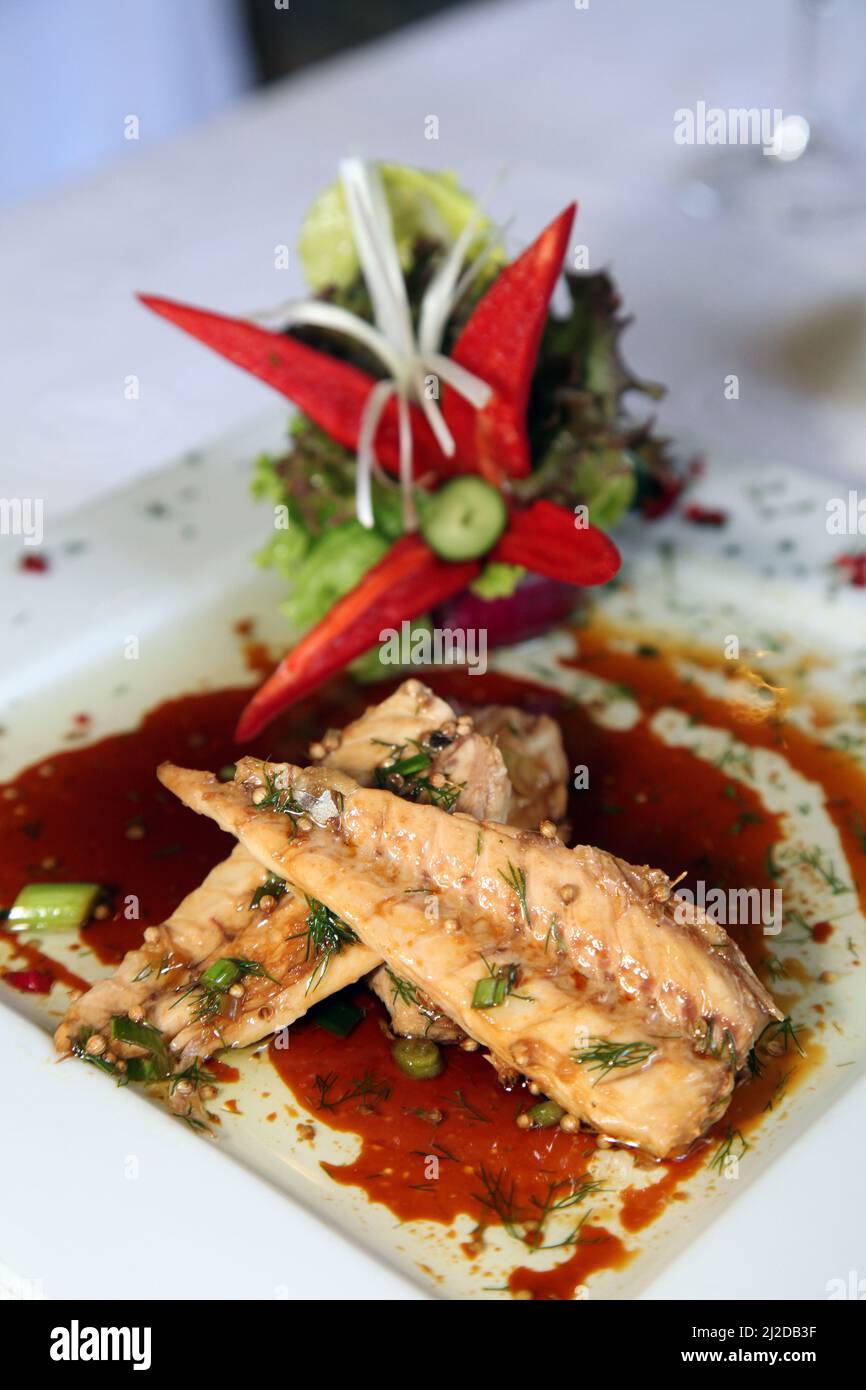 Bonito fish with sauce on the restaurant table Stock Photo - Alamy