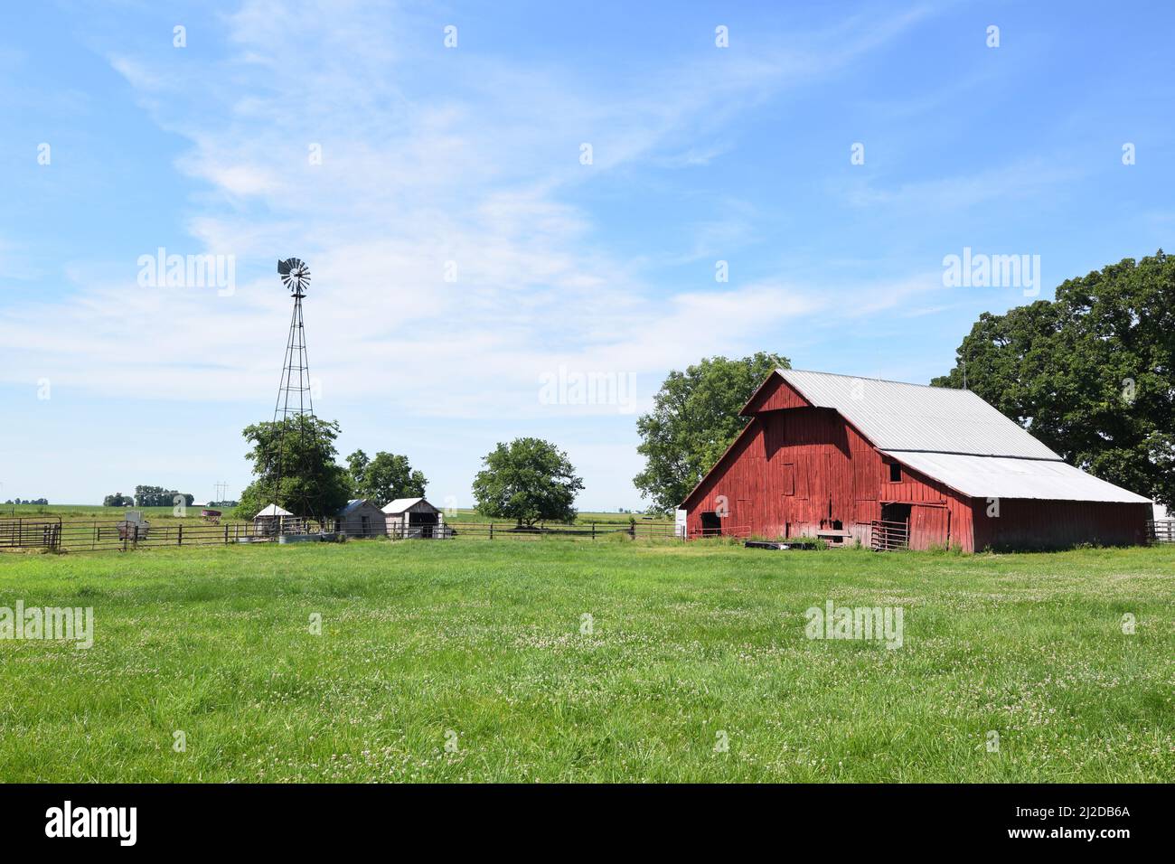 An iconic farm in rural east central Illinois, a red barn, windmill and ...