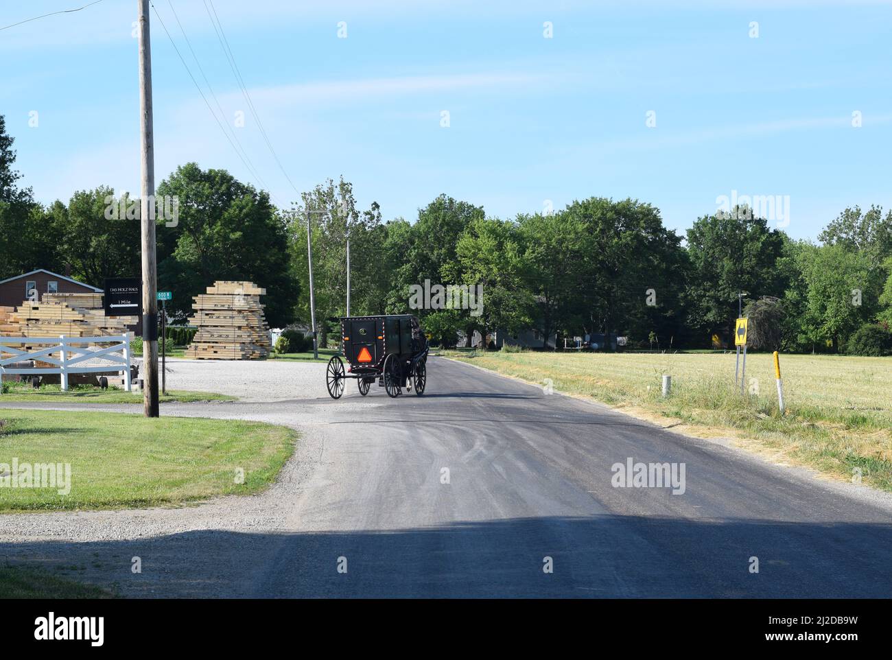 A horse drawn covered Amish buggy on a road near Arthur, Illinois Stock ...
