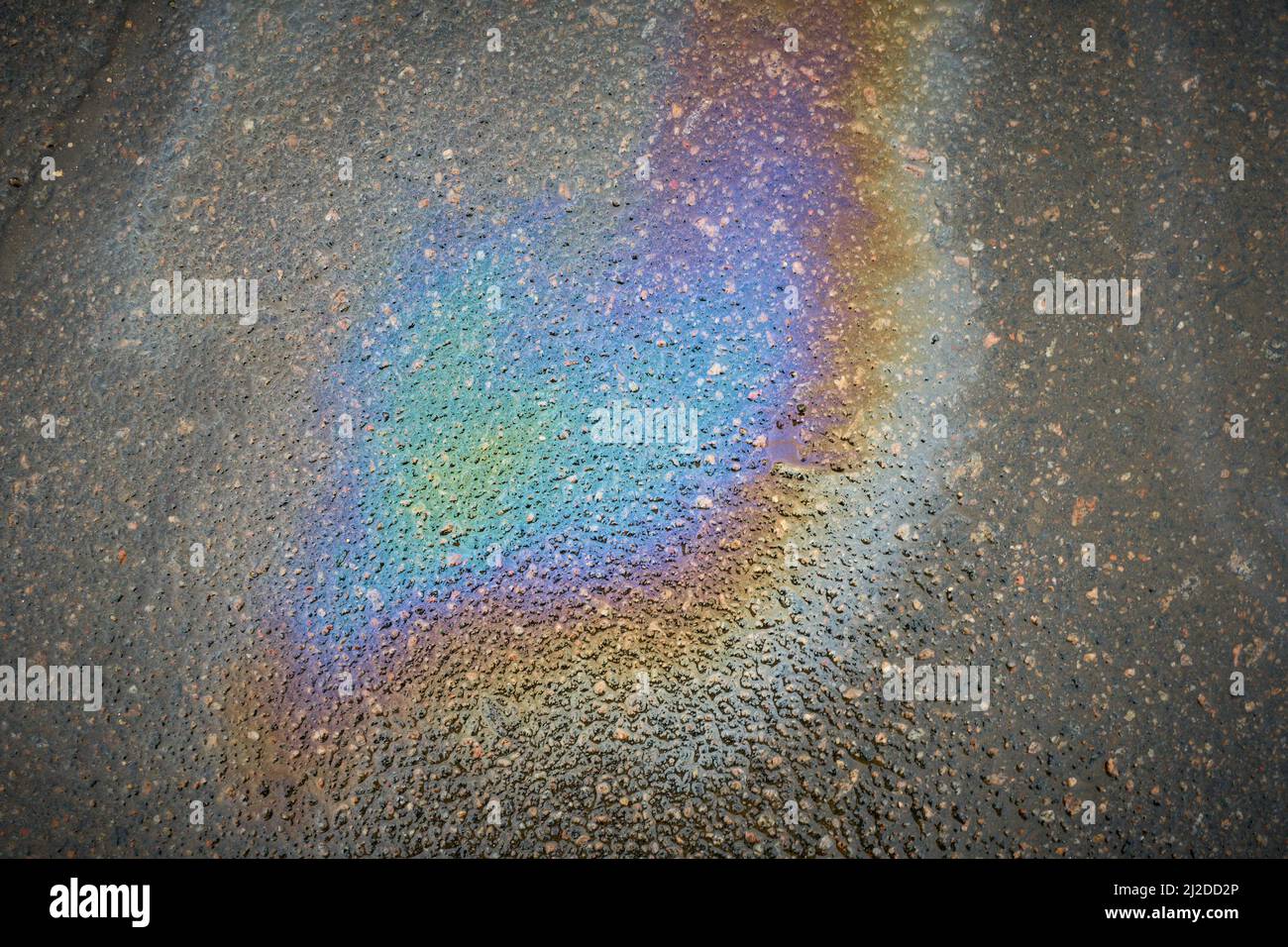 Oil slick on the asphalt road background. Rainbow gasoline oil spill on ...
