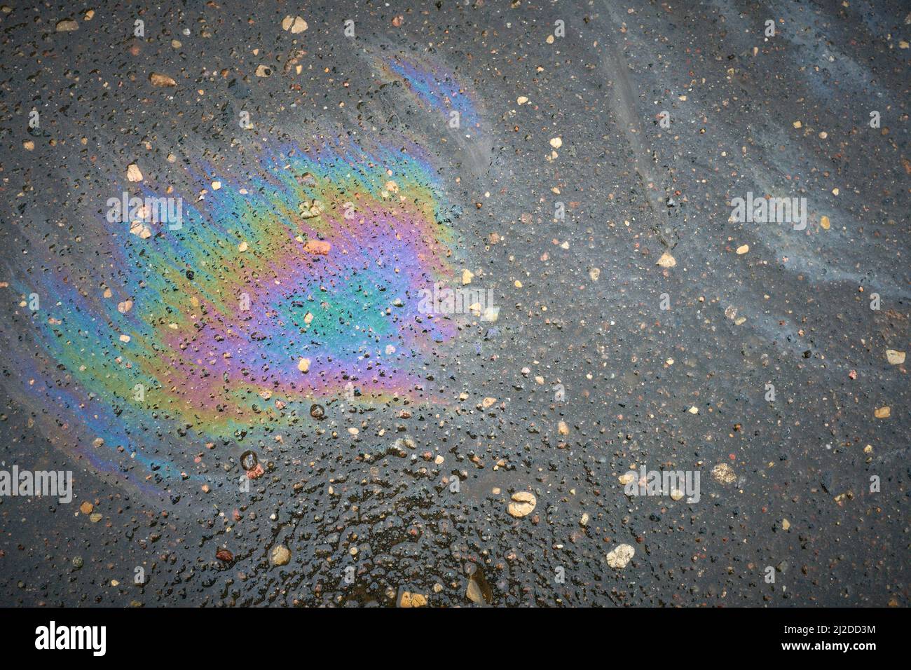 Oil stain with rainbow colors on a wet asphalt road Stock Photo - Alamy