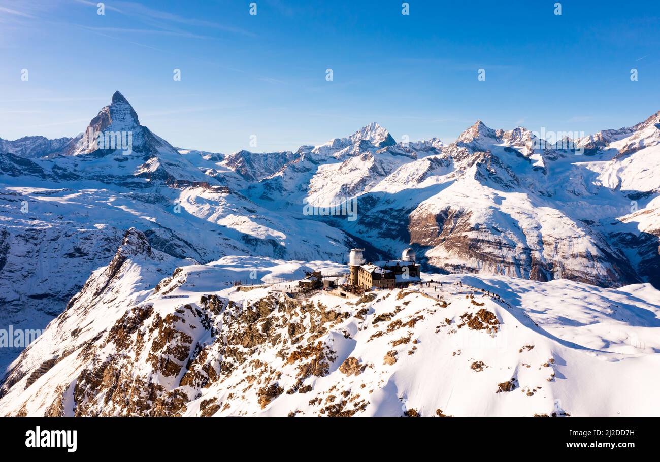 Winter Alpine landscape of Gornergrat ridge with observatory and ...