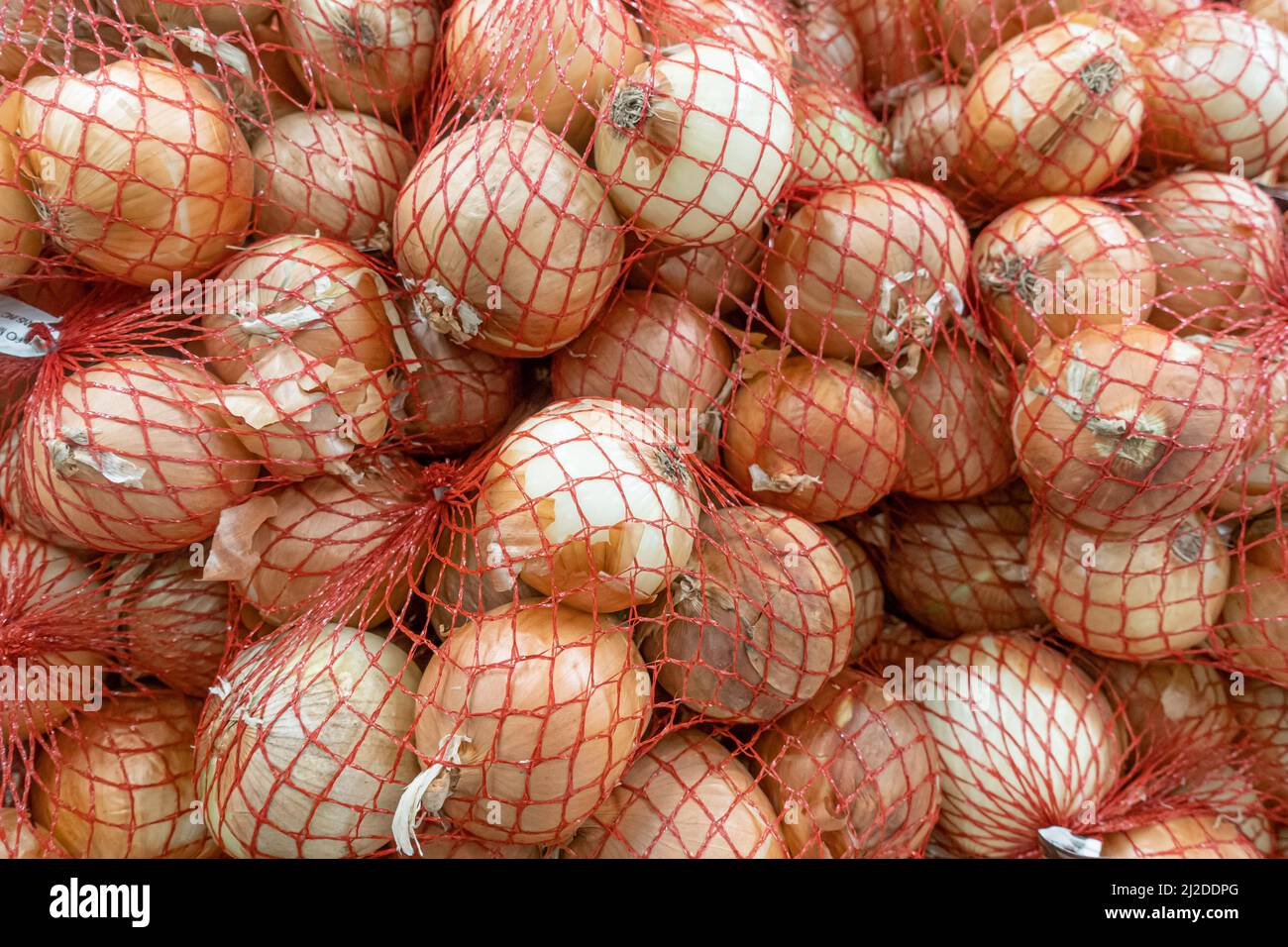 Bag of fresh organic onions on display in supermarket Stock Photo - Alamy